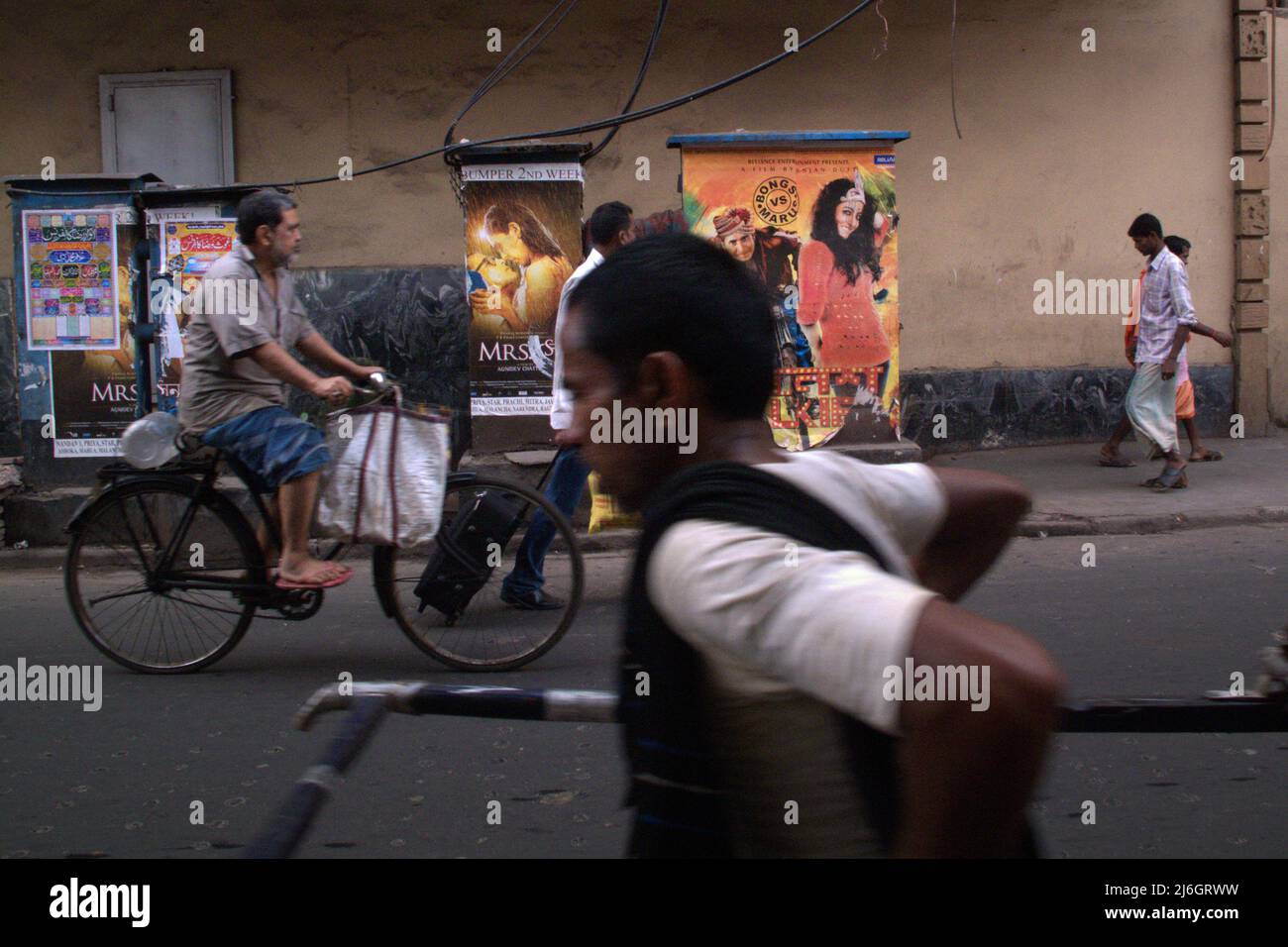 Rickshaw puller, cyclist and pedestrians in Kolkata, West Bengal, India ...