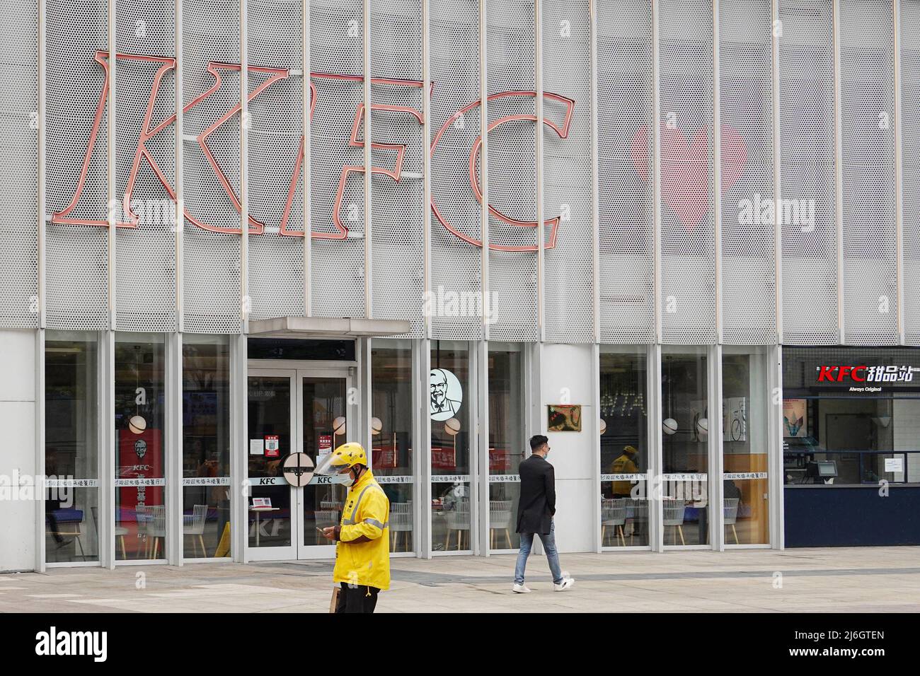 The delivery man walks past the KFC restaurant Stock Photo - Alamy