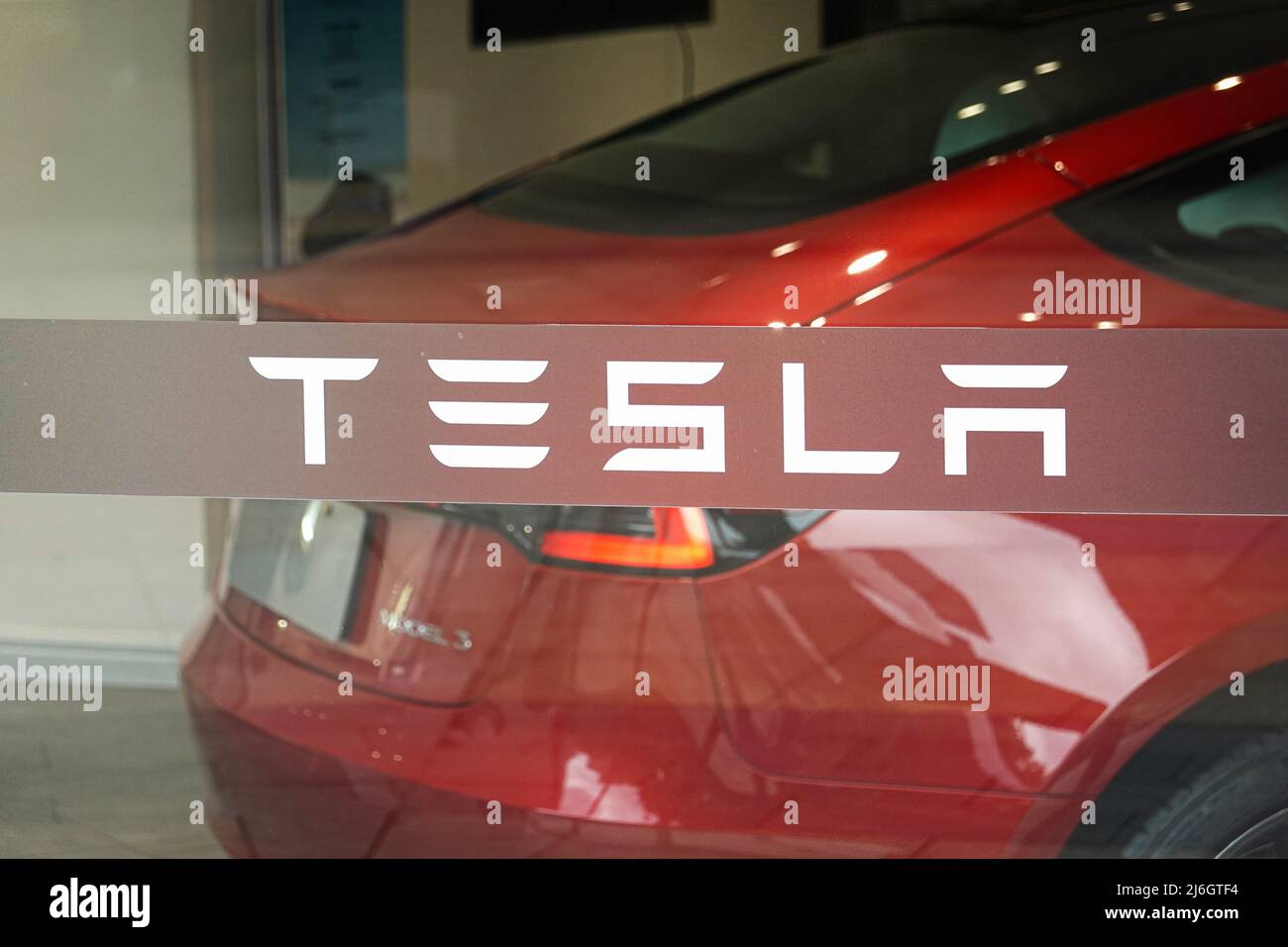 The Tesla logo is pasted on the floor-to-ceiling Windows Stock Photo ...