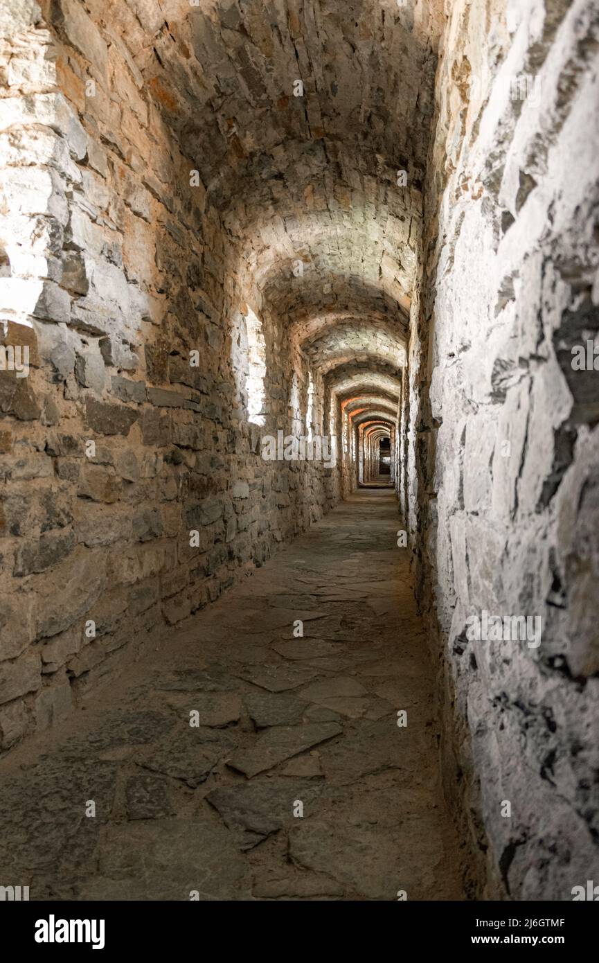Stone Tunnels. Narrow balcony corridor with brick walls in the castle ...