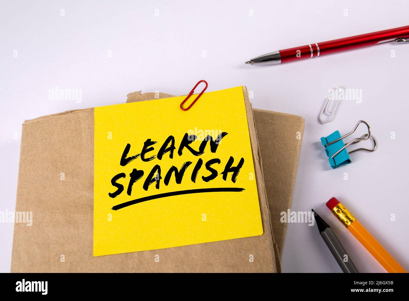 Learn Spanish. Textbooks and stationery on a white background Stock ...