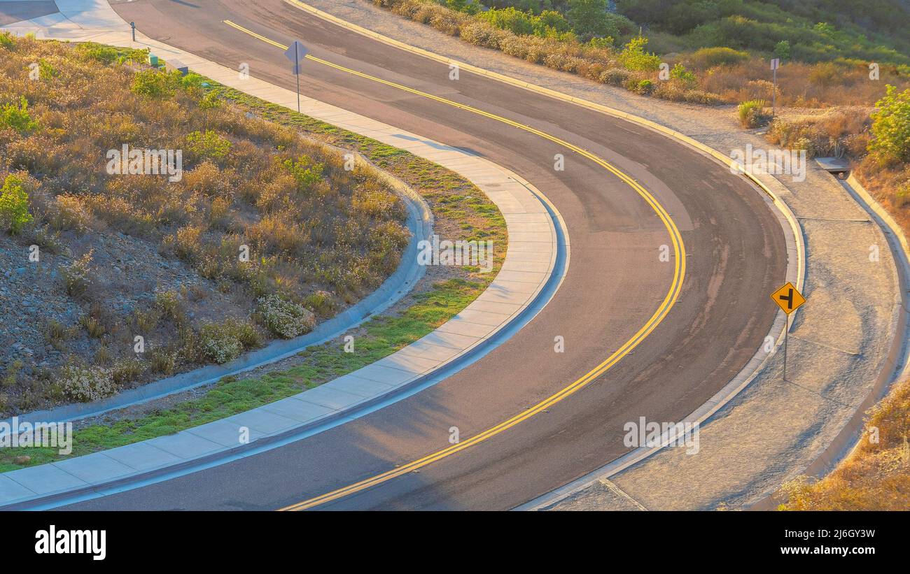 Panorama High angle view of a winding road with road intersection sign ...