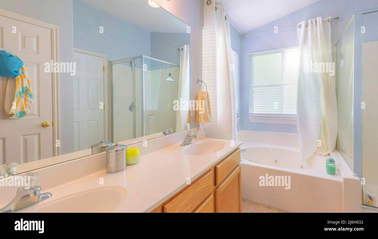 Panorama Sun flare Bathroom with light blue walls and windows at the ...