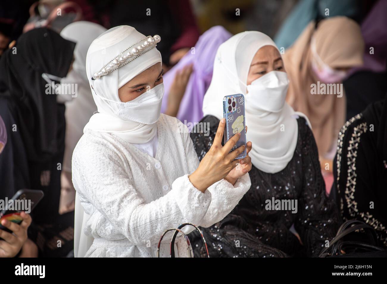 A muslim girl takes a selfie during Eid al-Fitr prayers at the ...