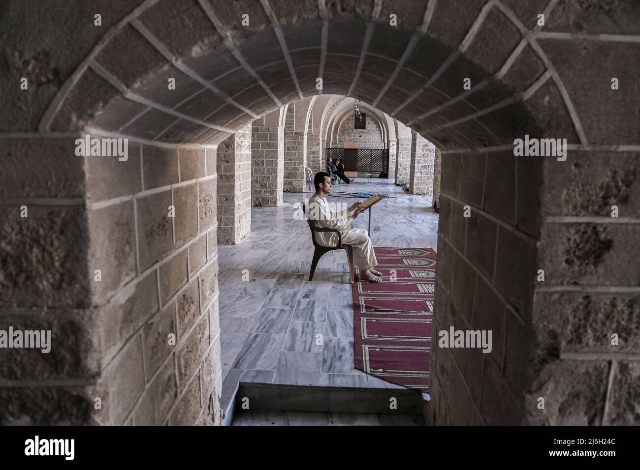 A Palestinian reads the Qur'an at Al-Omari Mosque on the last day of ...