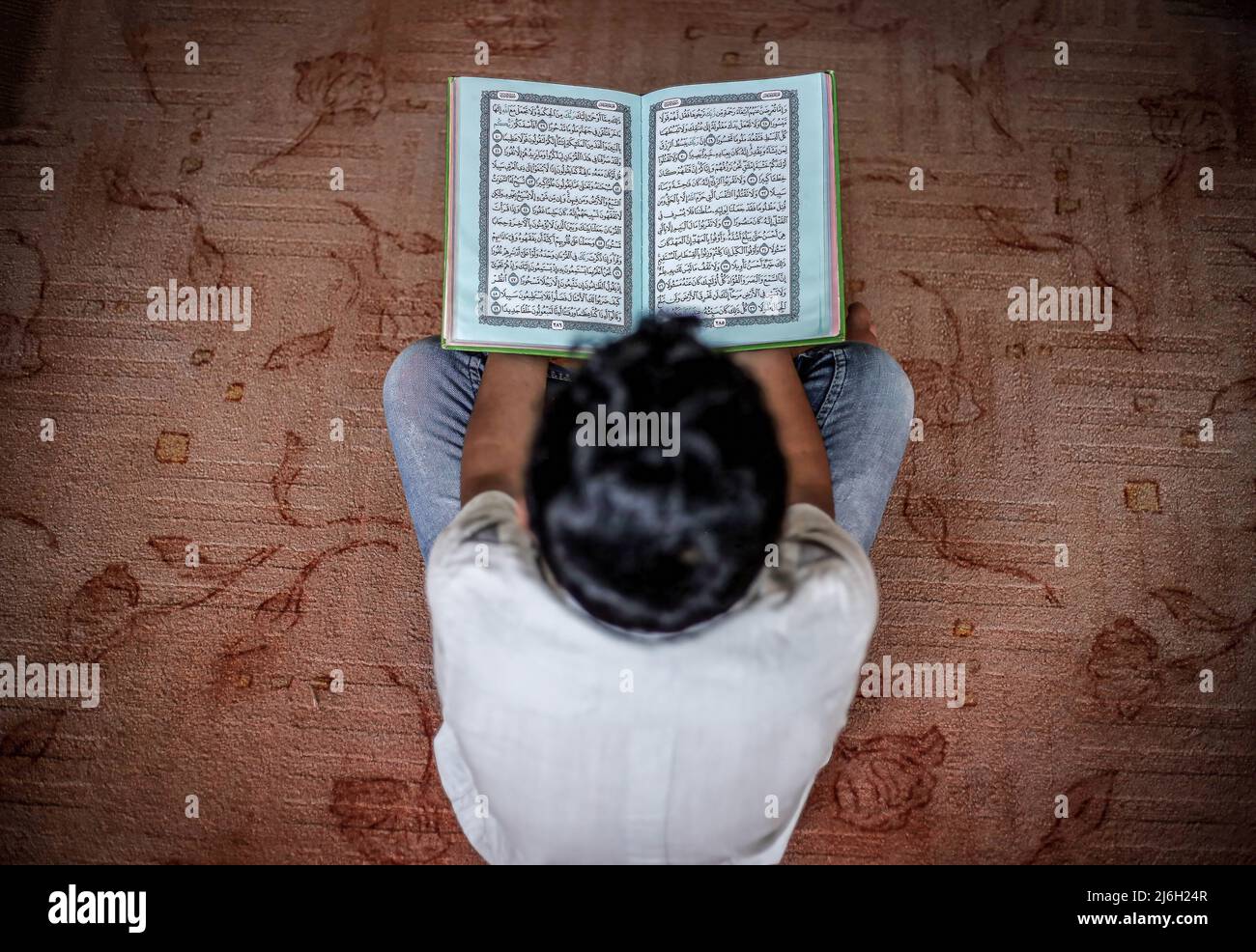 A Palestinian reads the Qur'an at Al-Omari Mosque on the last day of ...