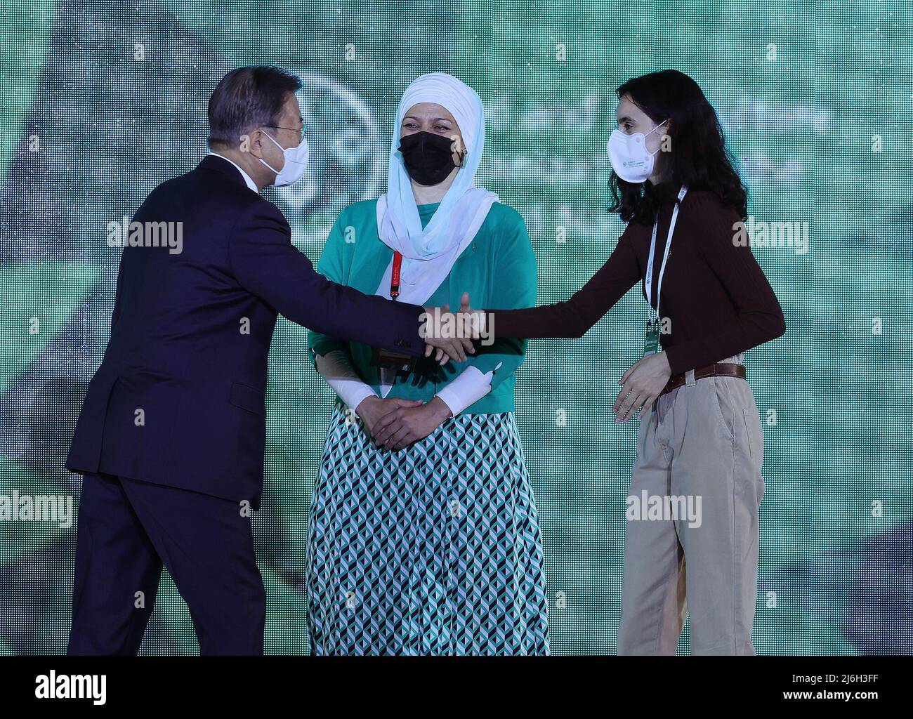 World Forestry Congress in Seoul President Moon Jae-in (L) shakes hands ...