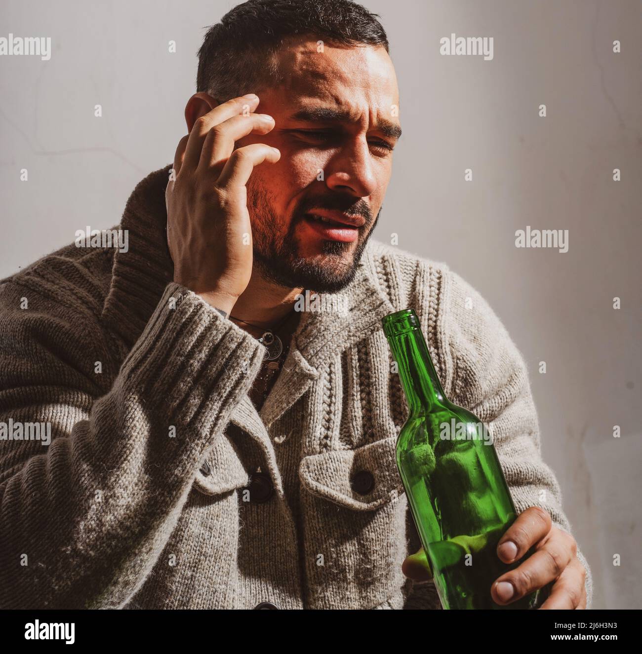 Alcoholic man with bottles wine cry. Depressed crying man. Drunk men ...
