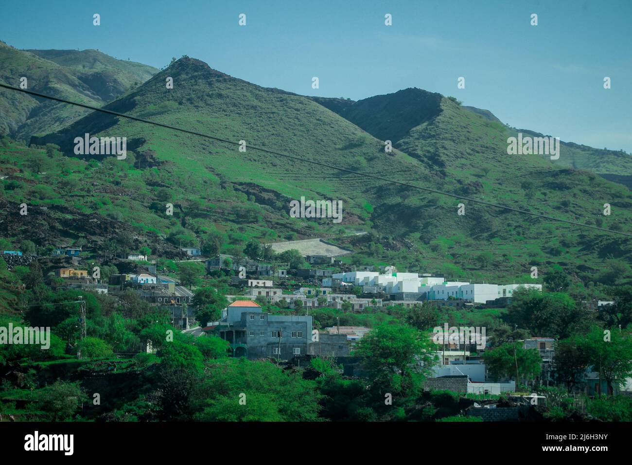 Houses next to the road leading to the hills of Fogo island on Cabo ...