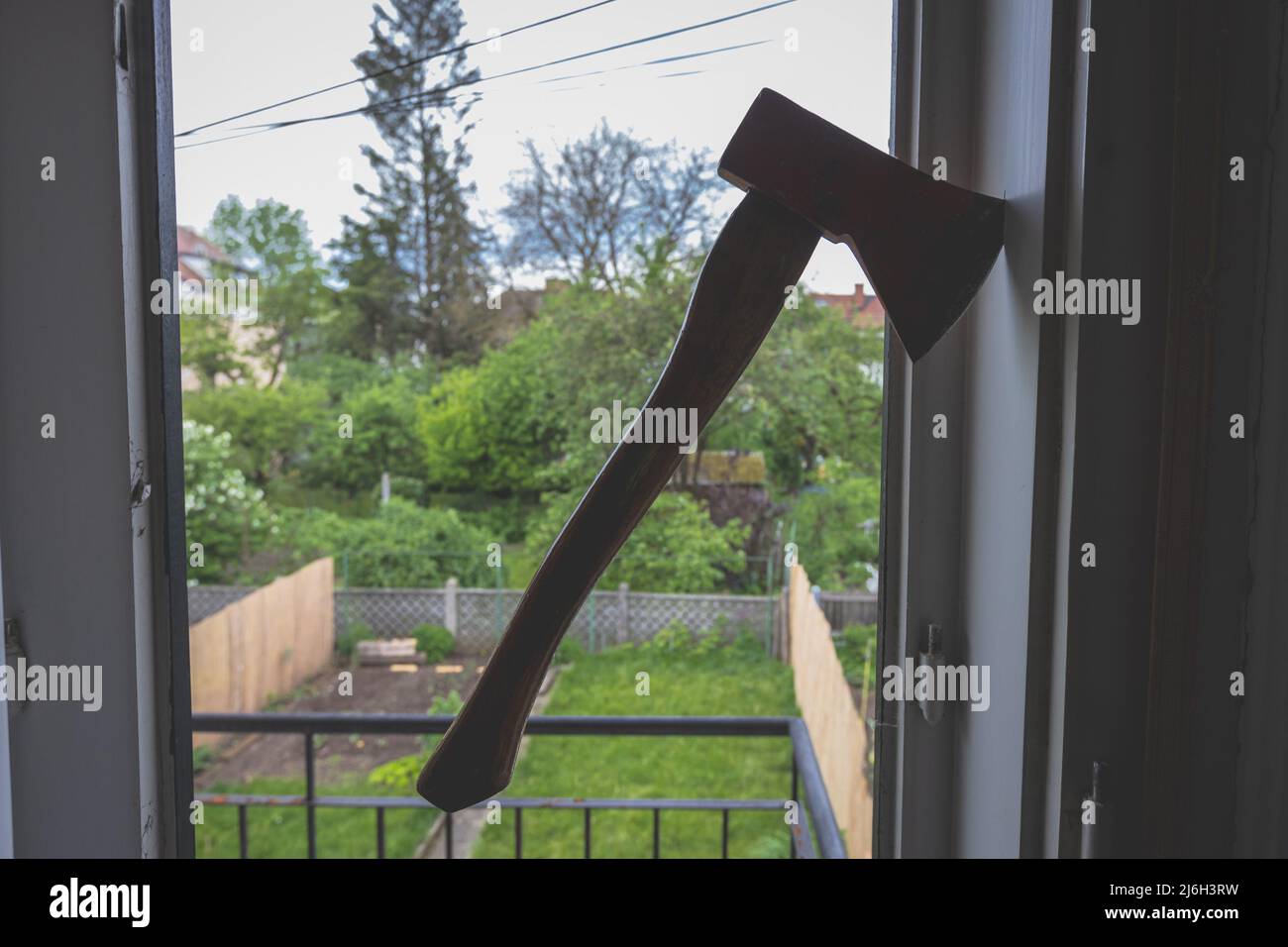 Old window pane made of wood being torn down using a common axe ...