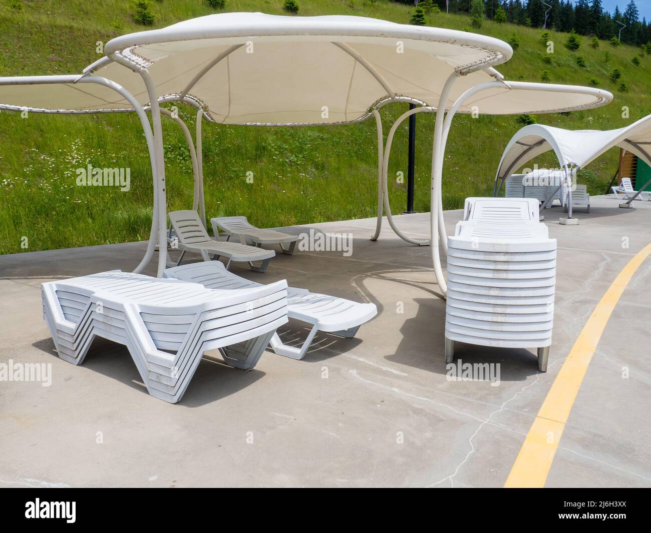 Empty sun loungers stand under a canopy Stock Photo - Alamy