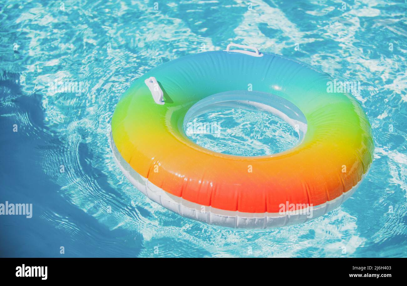 Inflatable rubber ring floating in a blue water in pool Stock Photo - Alamy