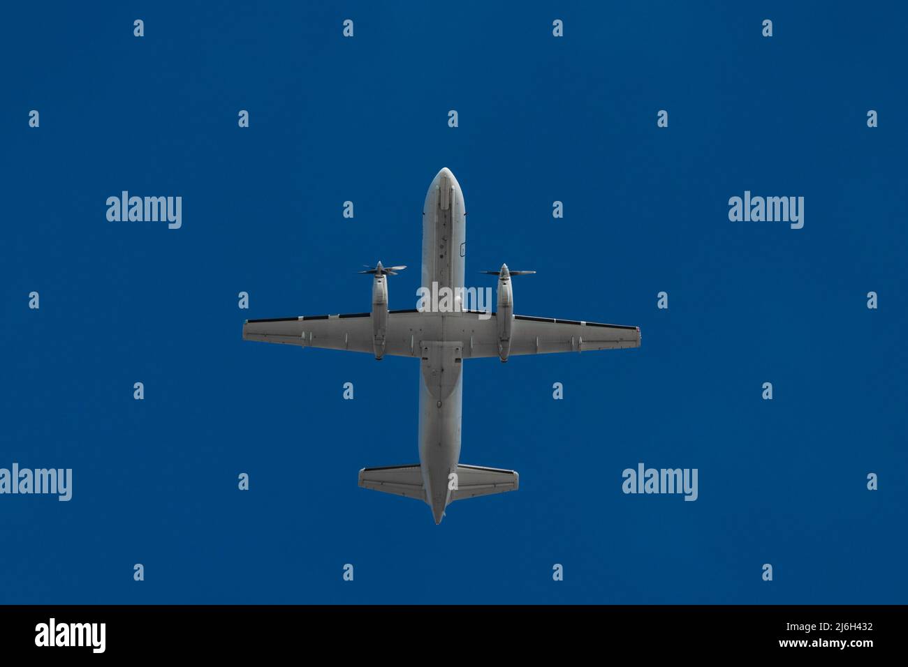Underside view of modern twin propeller engine descending from the ...