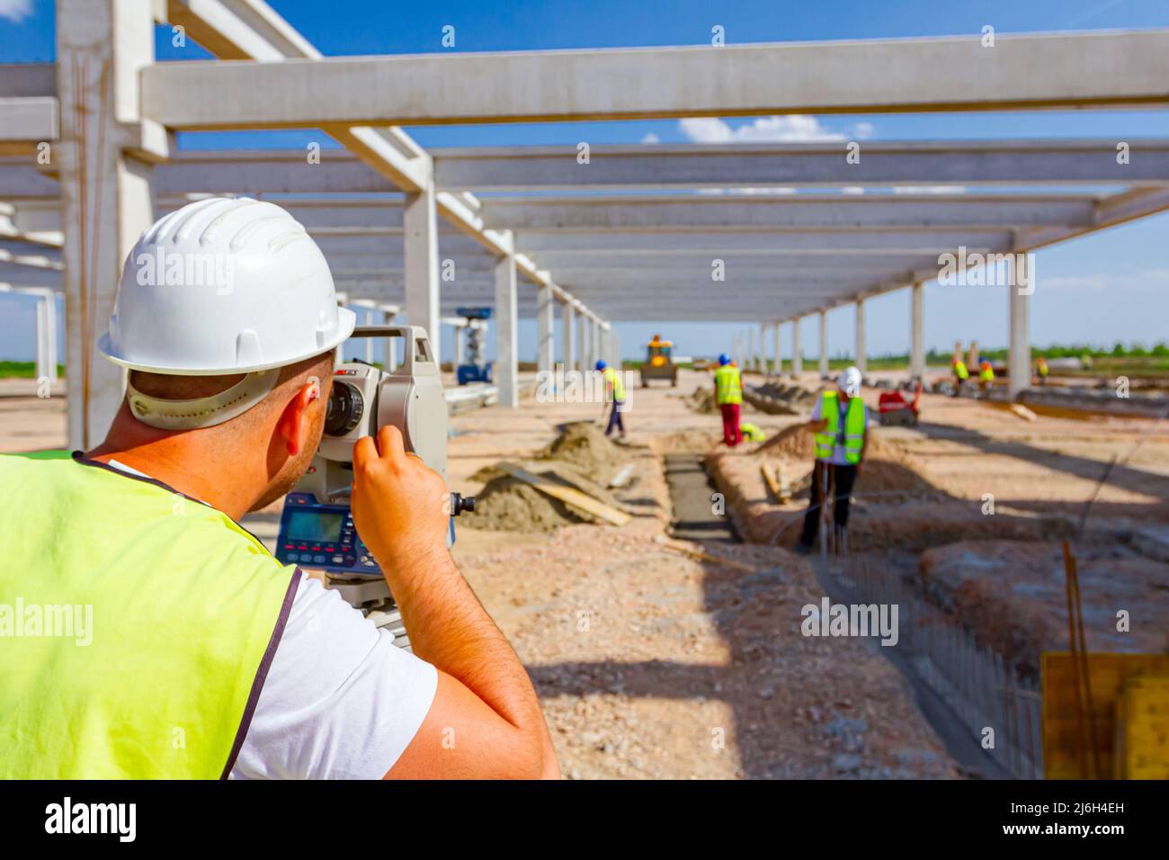 Surveyor engineer is measuring level on construction site. Surveyors ...