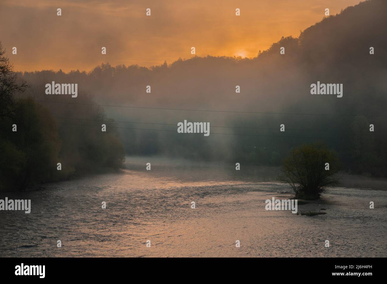 Romantic and misty morning on the river at sunrise, layers of fog are ...