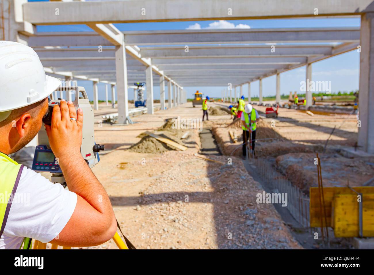 Surveyor engineer is measuring level on construction site. Surveyors ...