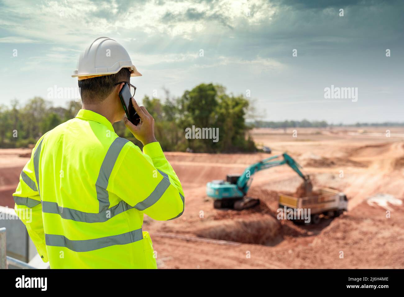 A civil engineer is using a construction telephone on the construction ...