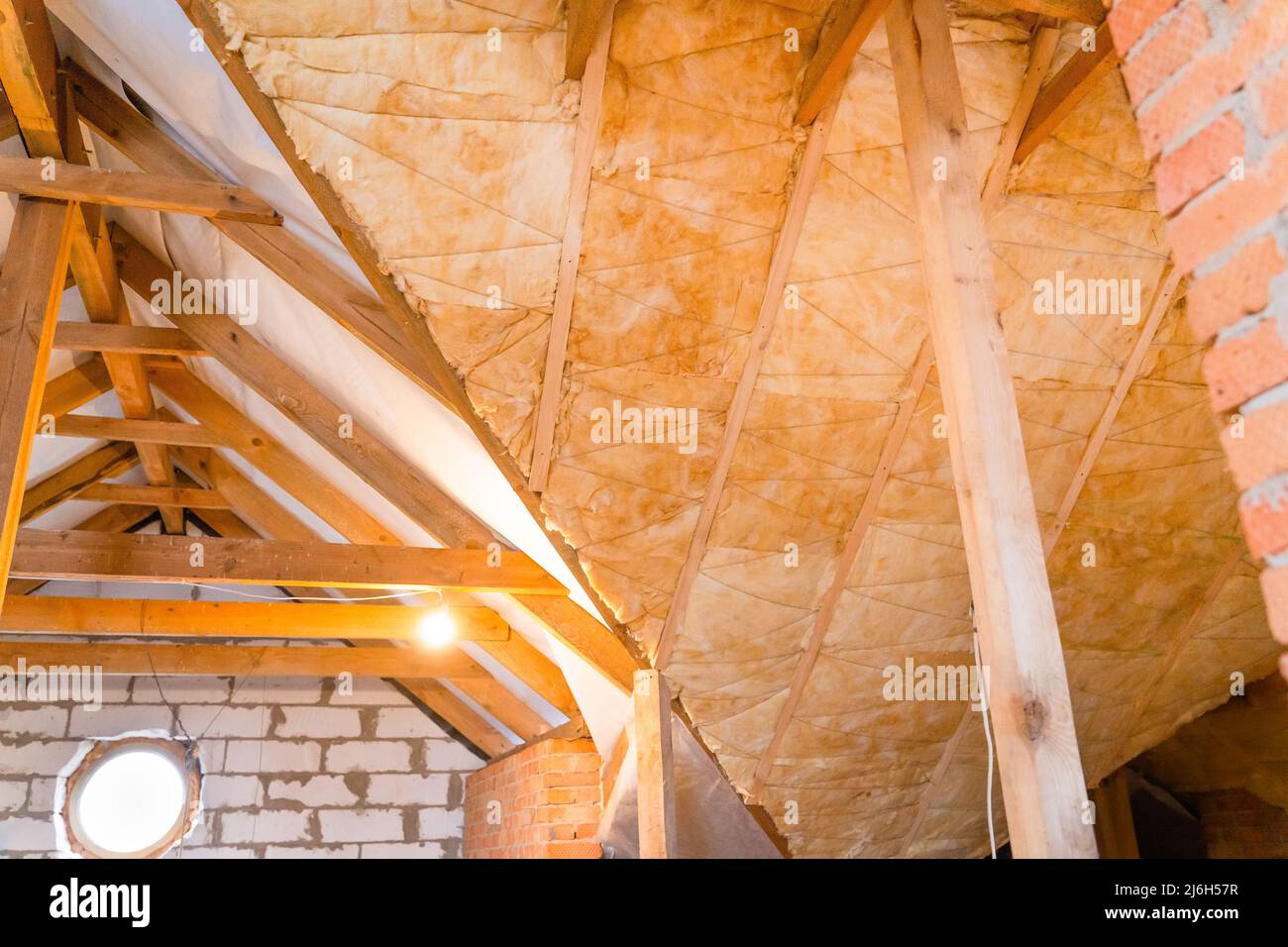 Glass roof insulation. Twine plastic thread supports the insulation ...