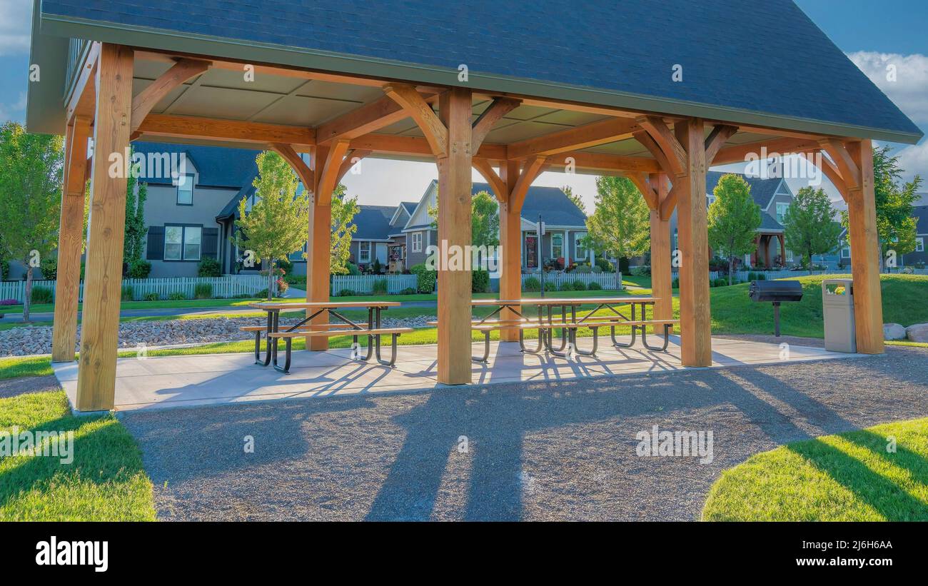 Panorama White puffy clouds Pavilion with three picnic tables in a ...