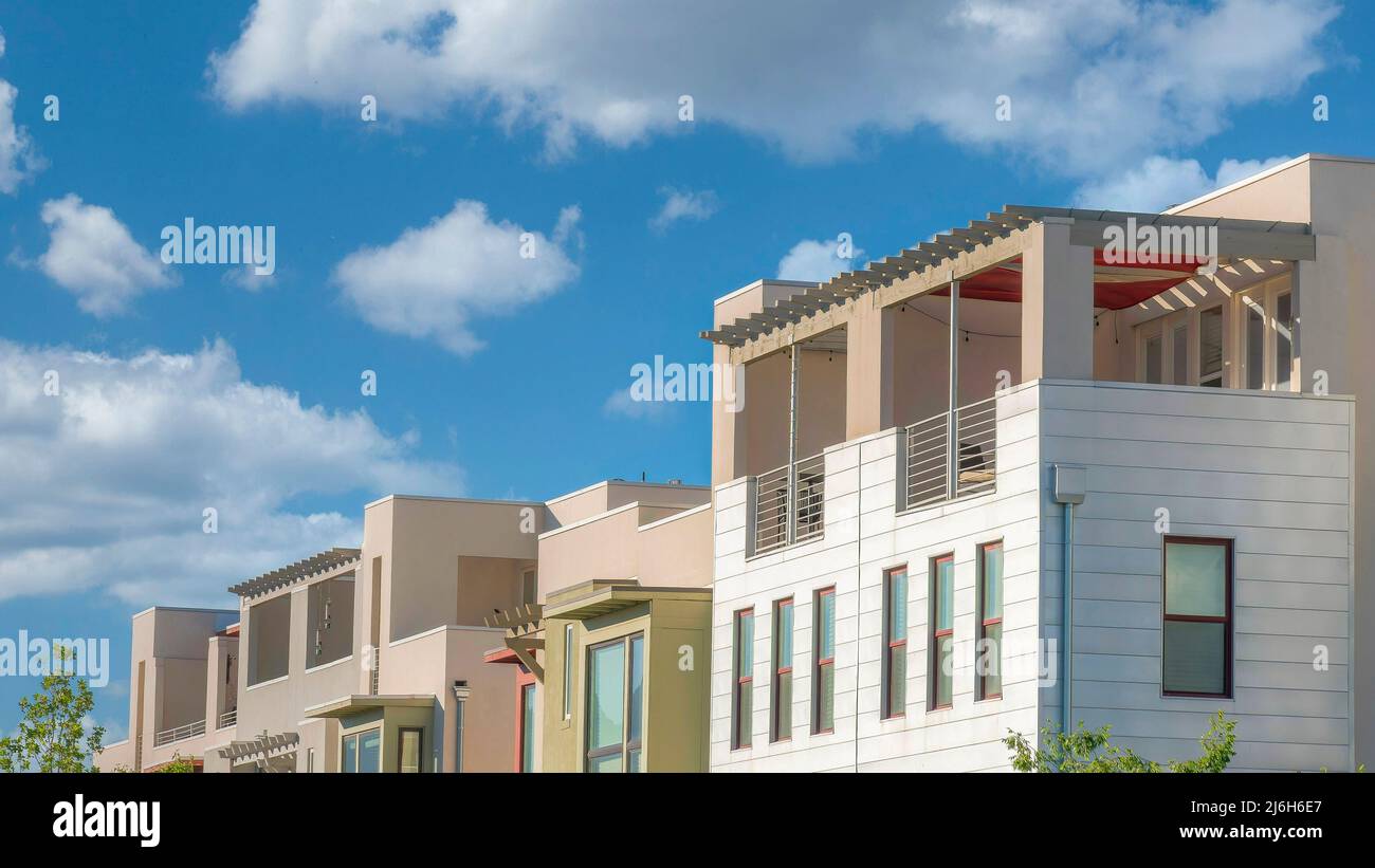 Panorama White puffy clouds Modern complex buildings with white wall ...
