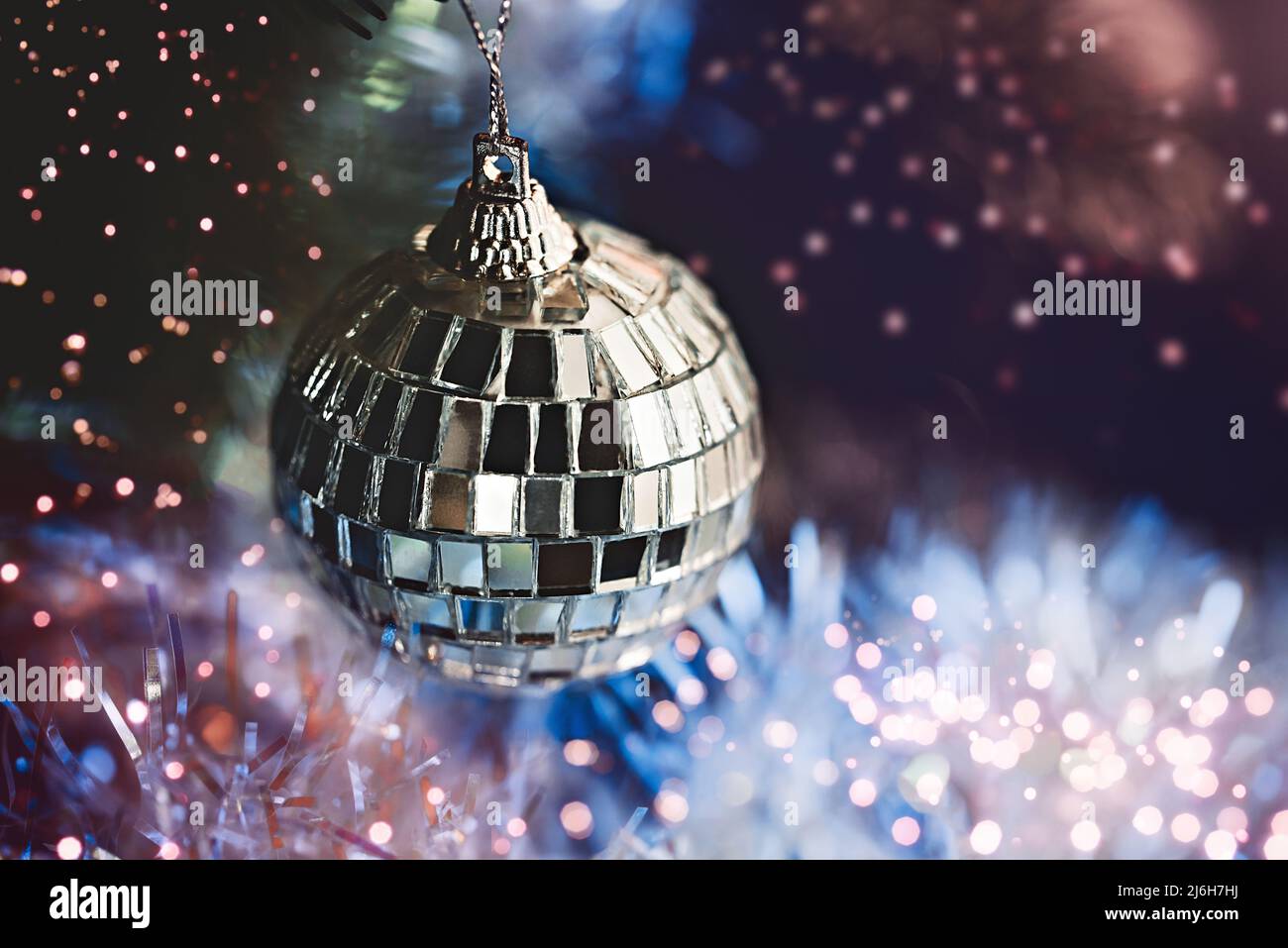 Closeup of Christmas disco ball on blurred, sparkling and fairy light ...