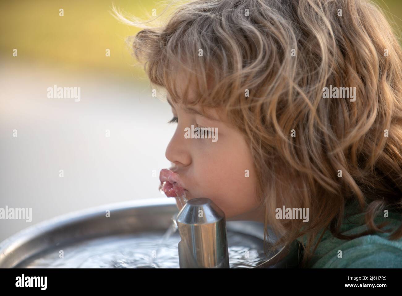 Child drinking water from a water fountain in park Stock Photo - Alamy