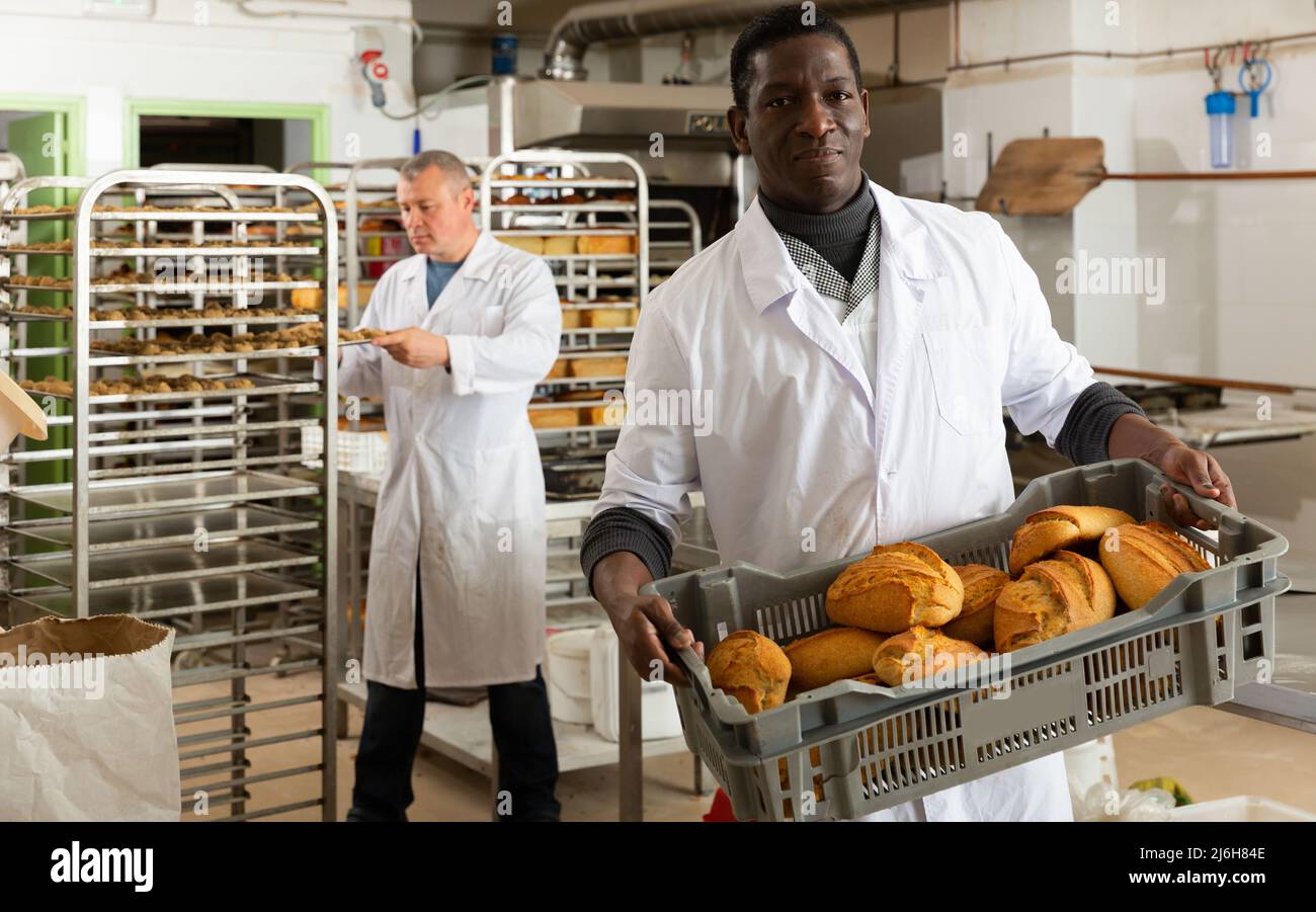 Portrait of successful baker during daily work in bakeshop Stock Photo ...