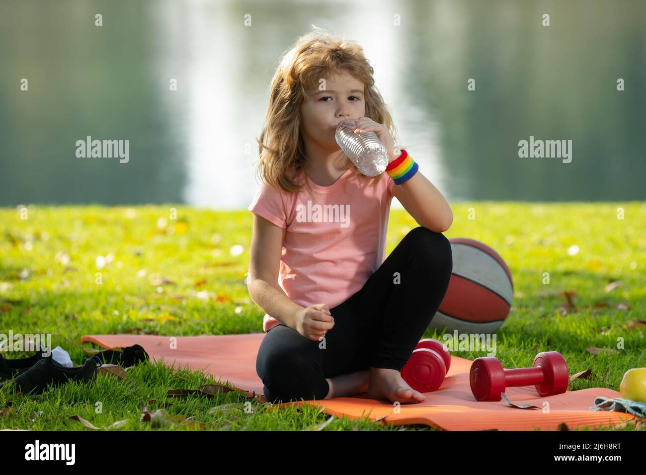 Child boy eating healthy food, drinking water after exercise. Fitness ...