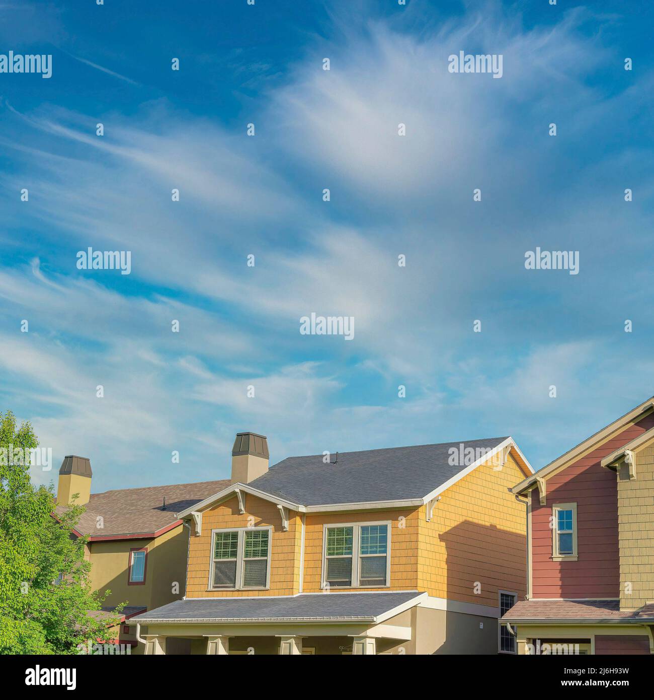 Square Whispy white clouds Home exterior with colorful shingles siding ...