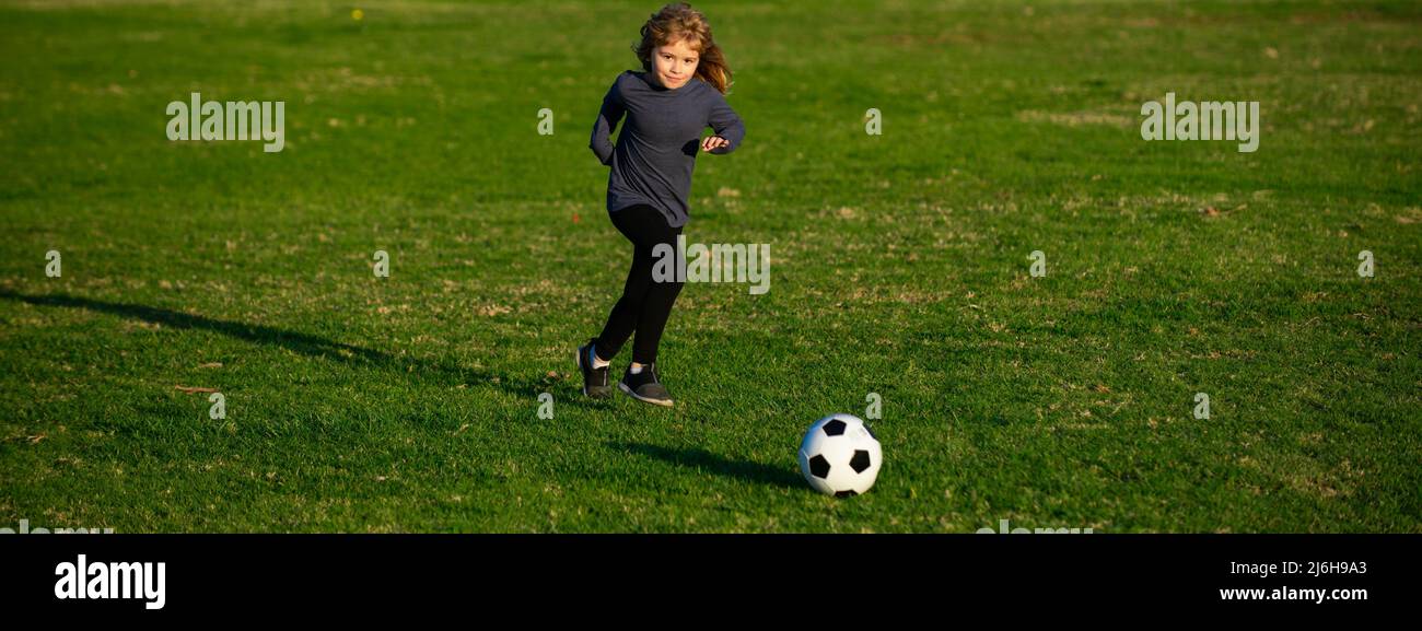 Soccer kid. Kids play football on summer stadium field. Little child ...