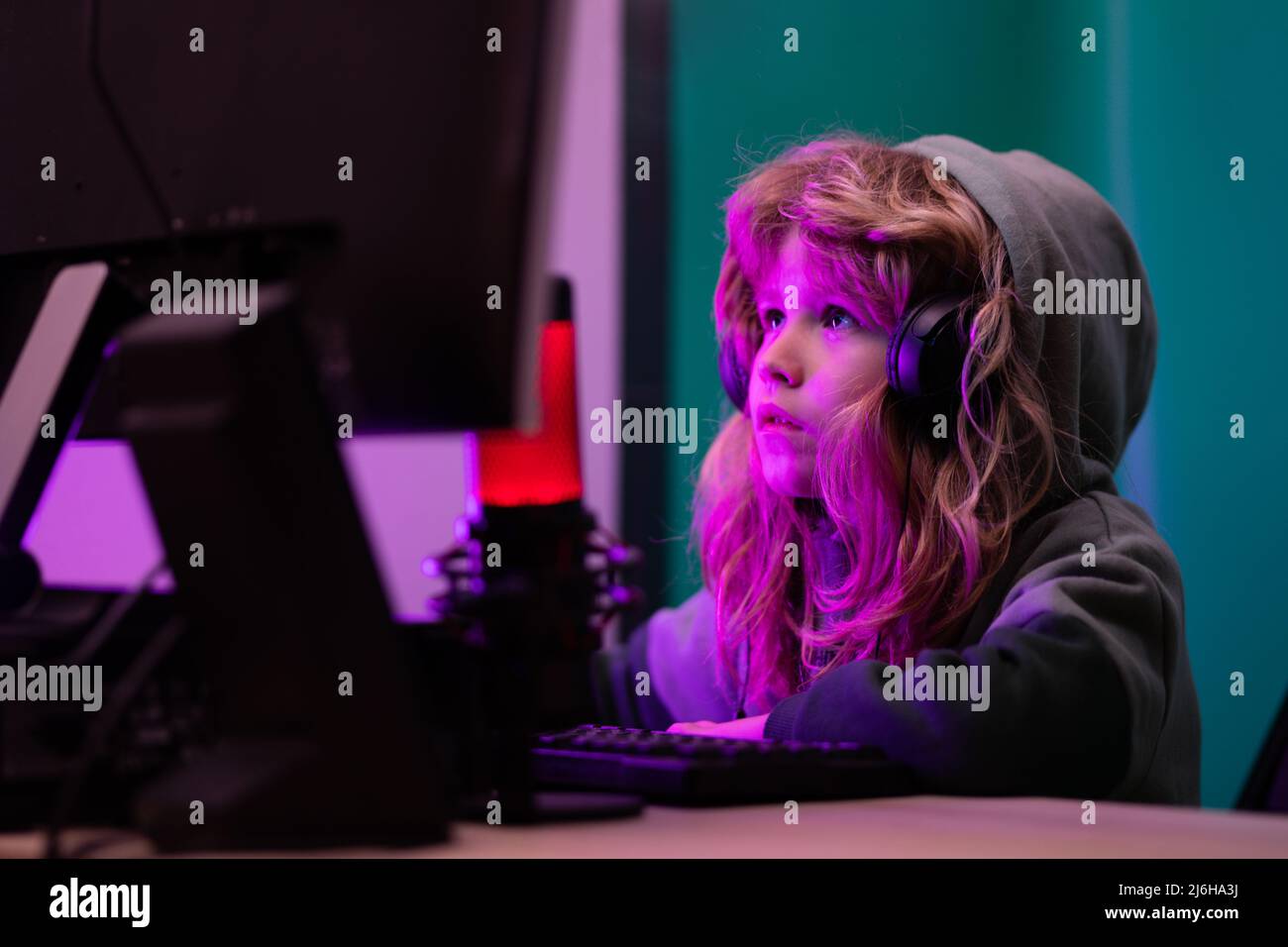 Little kid using desktop pc by night, child boy illuminated by the blue ...