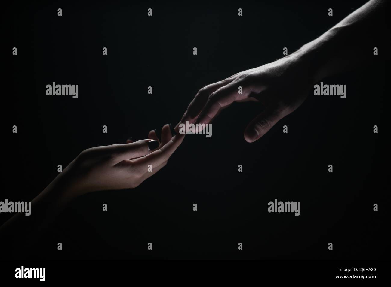 Hands gesturing on black background. Giving a helping hand. Support and ...