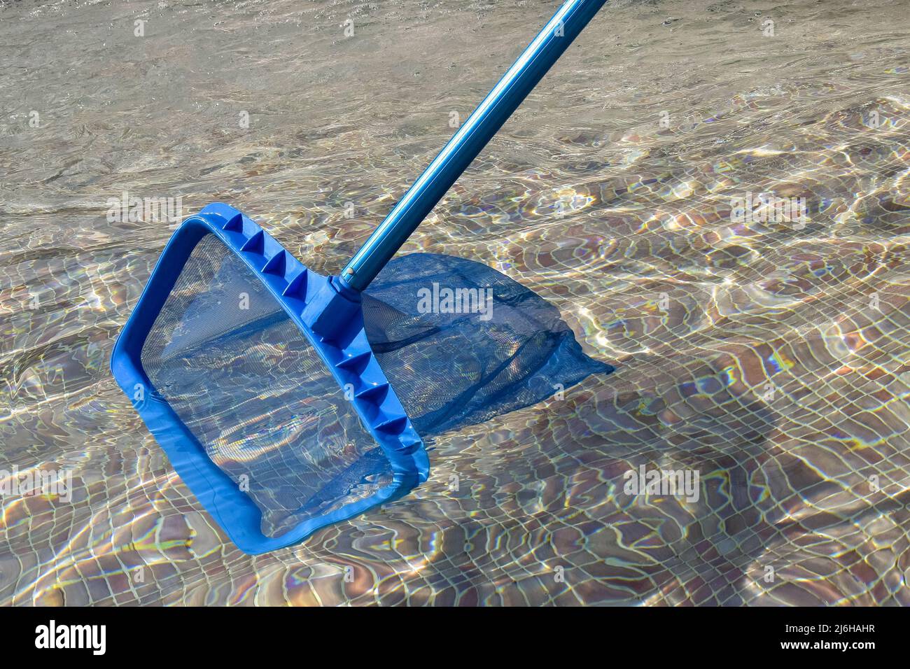 Cleaning pool, city fountain from garbage with special net. Clear water ...