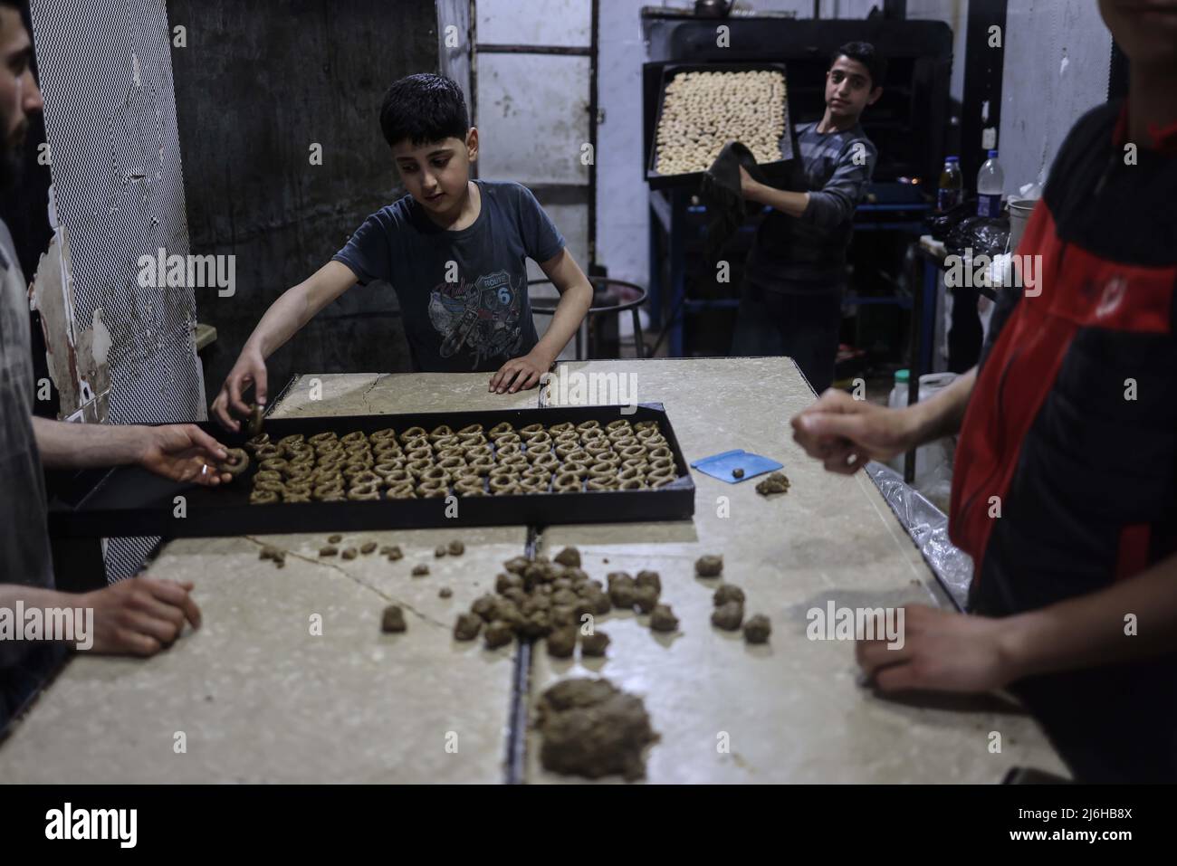 01 May 2022, Syria, Idlib: Syrian children prepare traditional sweets ...