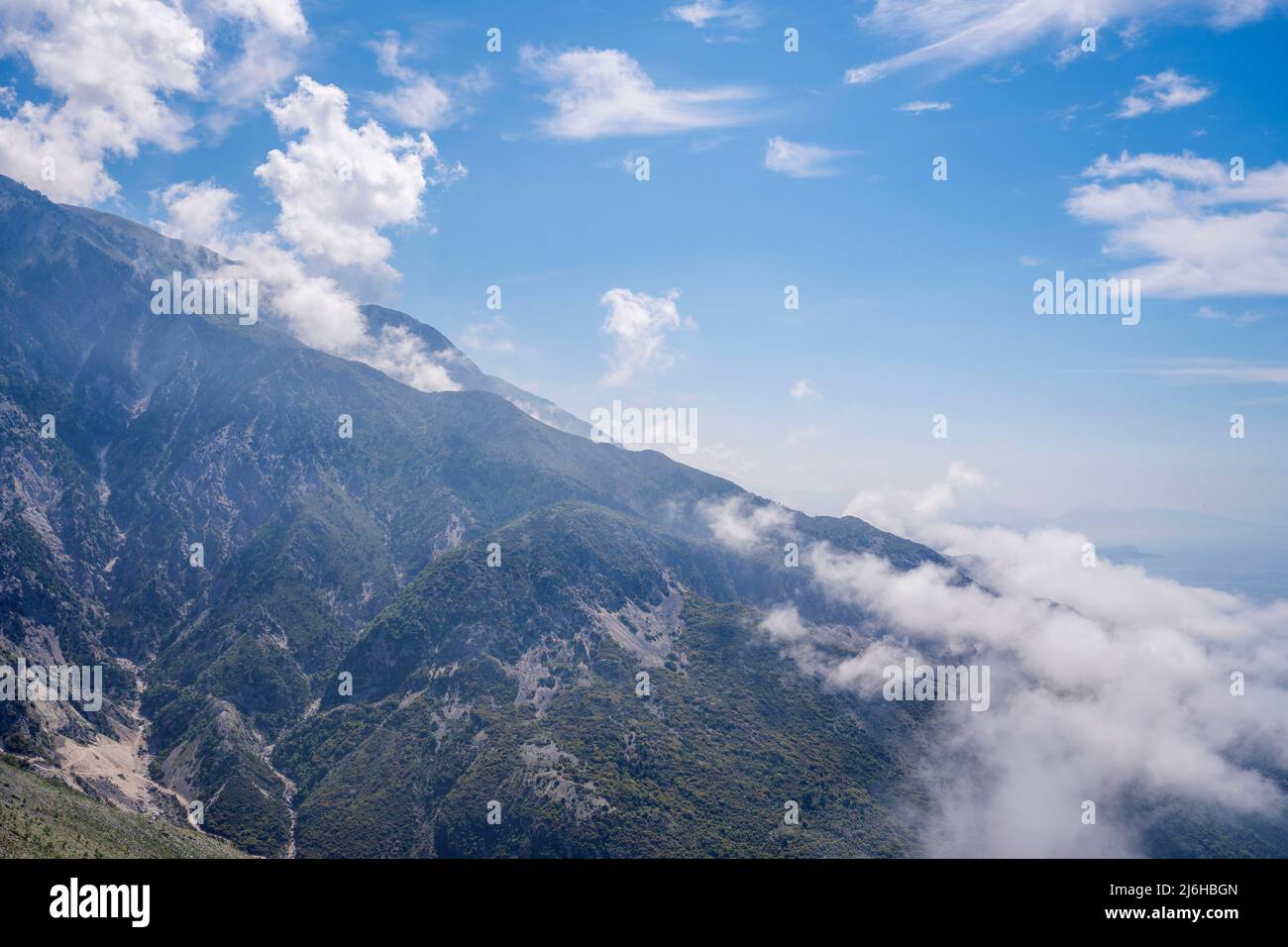 Sunny day high in the mountains, mountain peaks, blue sky, clouds on ...