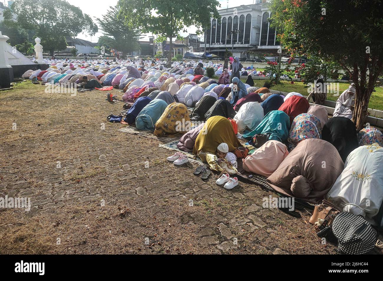 Believer woman is seen with her baby during prays momment to celebrates ...