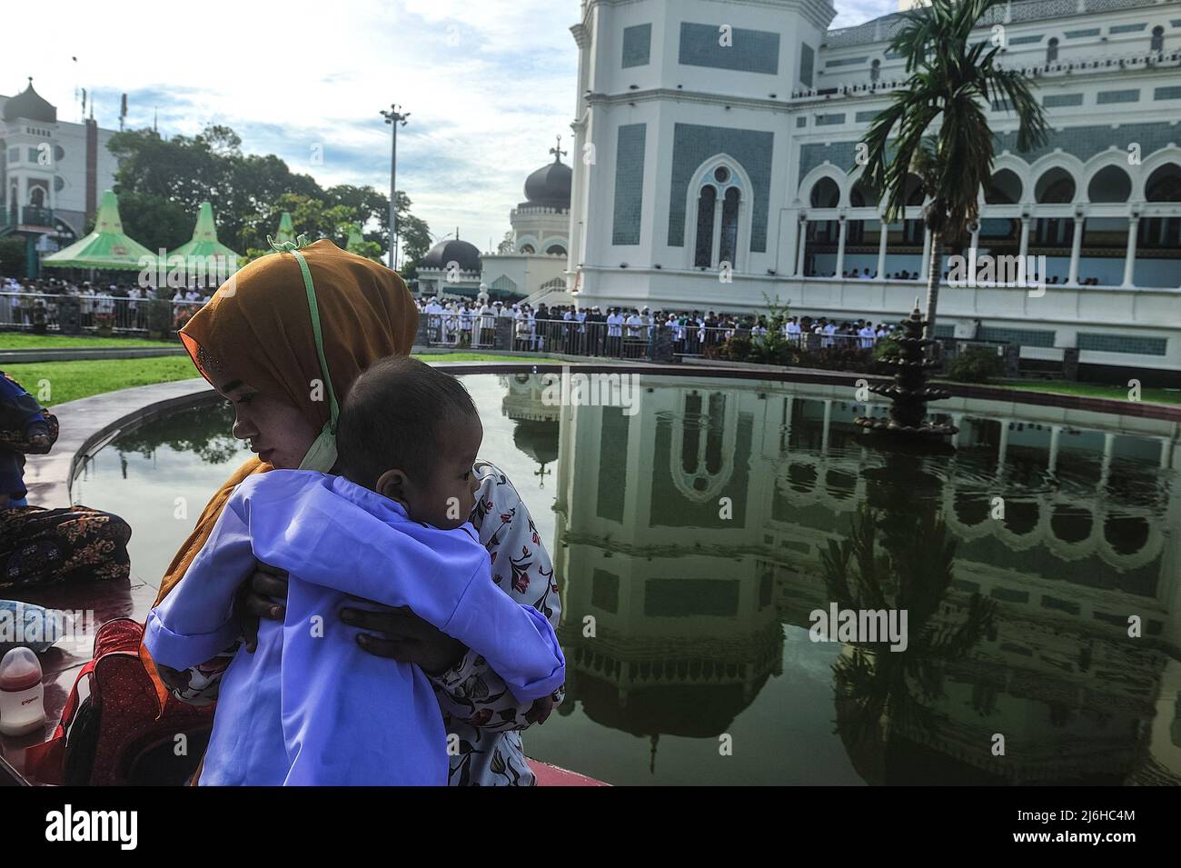 Believer woman is seen with her baby during the celebration of Eid Al ...