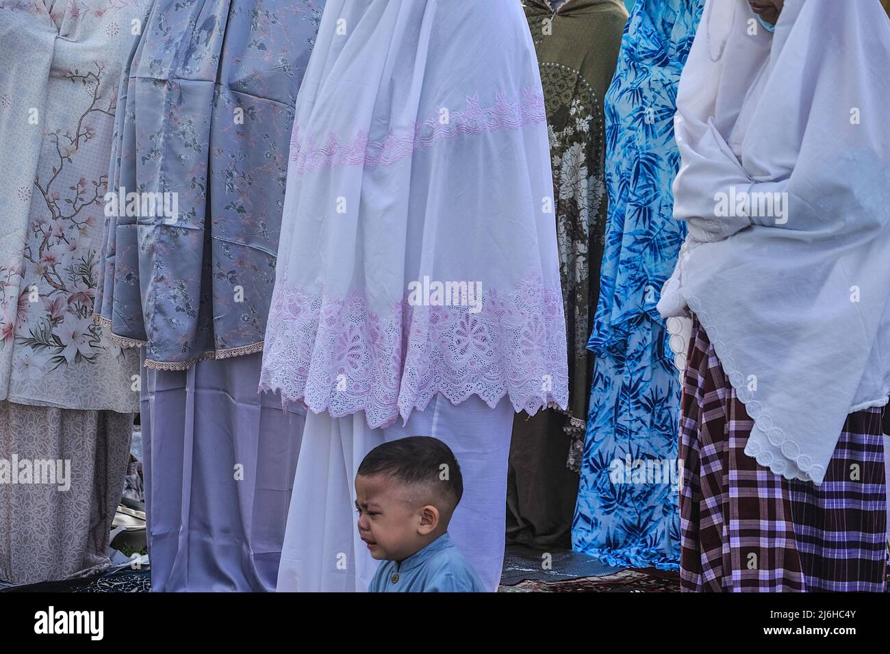 Believer woman is seen with her baby during prays momment to celebrates ...