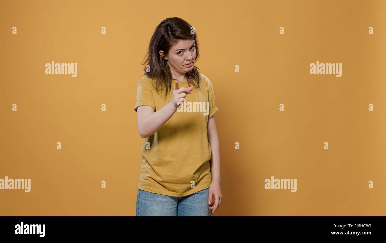 Angry upset woman arguing showing index finger pointing at guilty ...