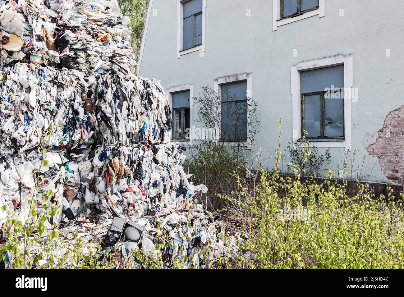 Bundles of litter in front of house Stock Photo - Alamy