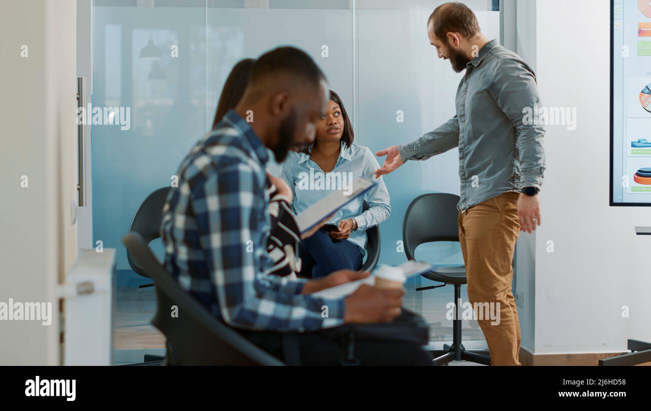 Office worker asking female candidate to join employment meeting ...