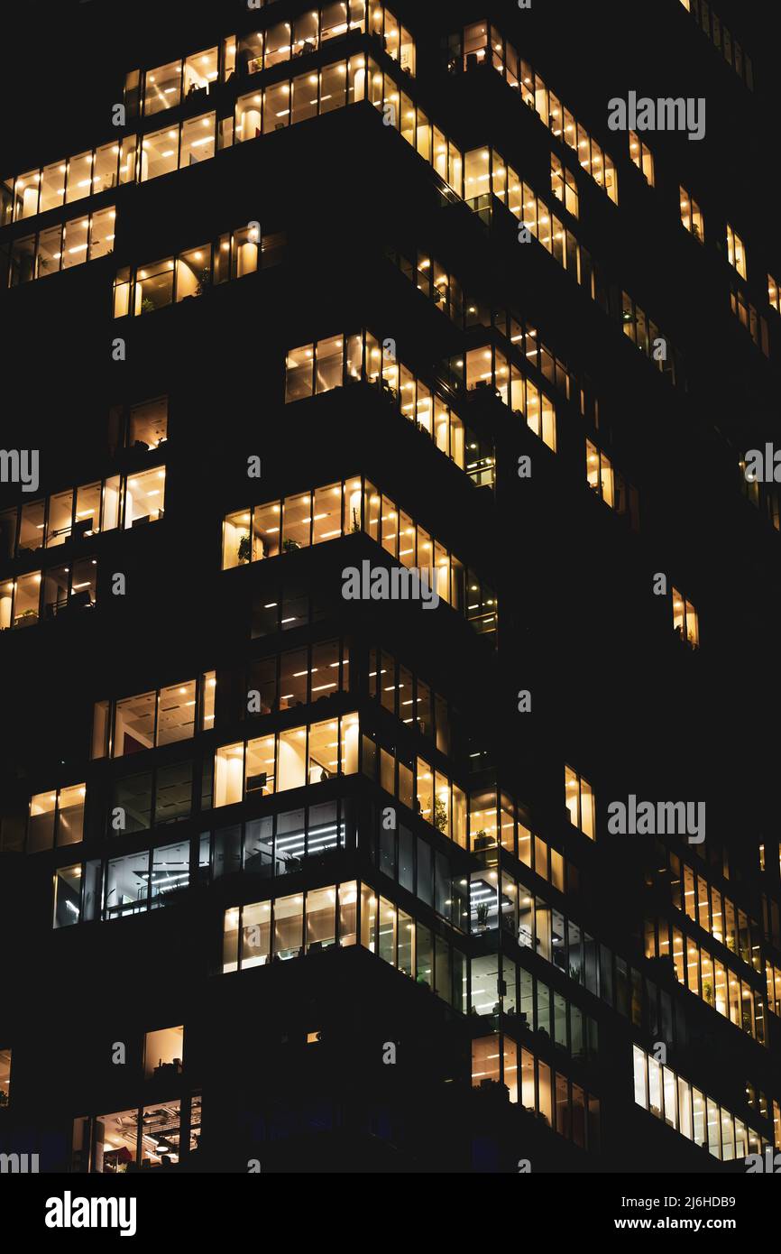 Corporate skyscraper windows at night, office building in financial ...