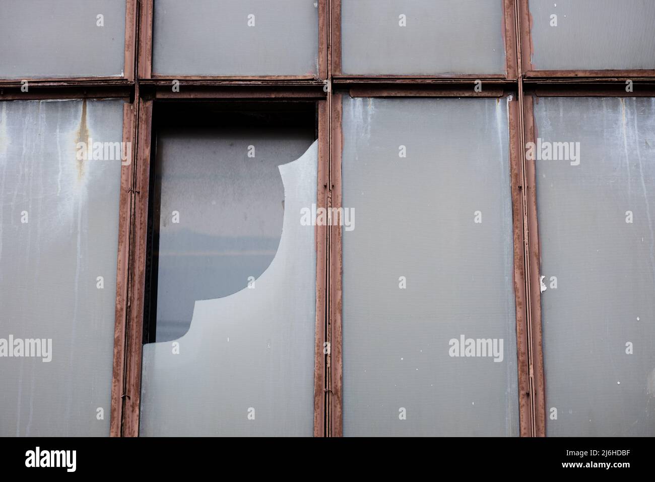 Old factory window with broken glass. Exterior old grunge building ...