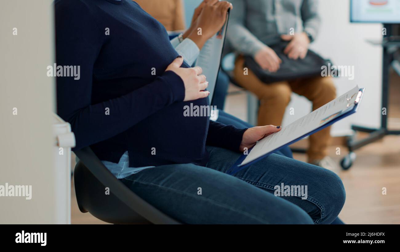Pregnant candidate rubbing baby bump and waiting in queue to join ...