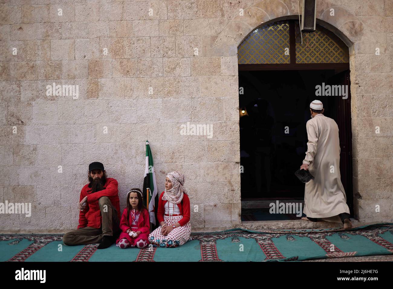 02 May 2022, Syria, Idlib: Syrian Muslims sit at a mosque in the city ...