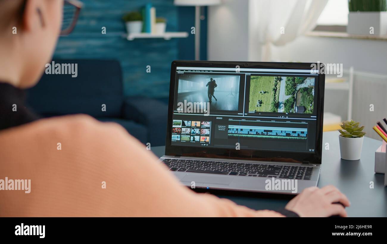 Design student working on video editing software to make montage ...