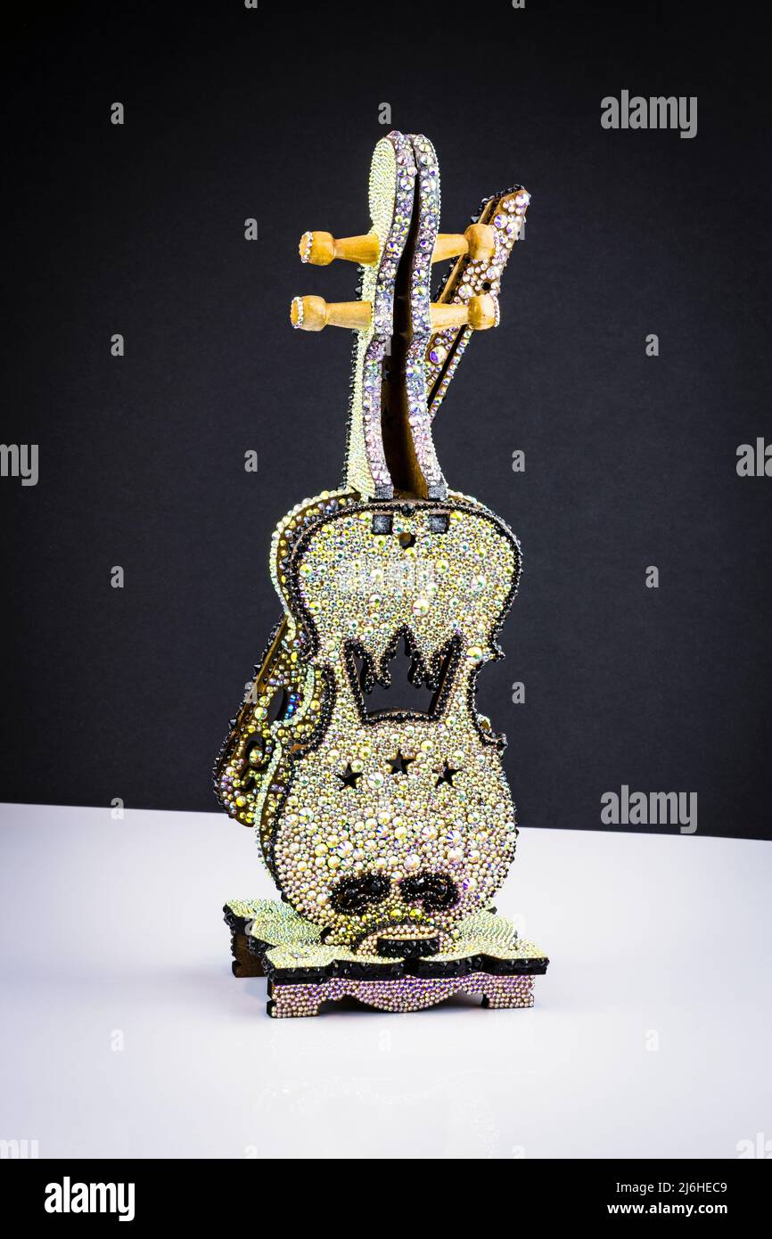 Violin with rhinestones. Decorative violin lined with rhinestones with ...