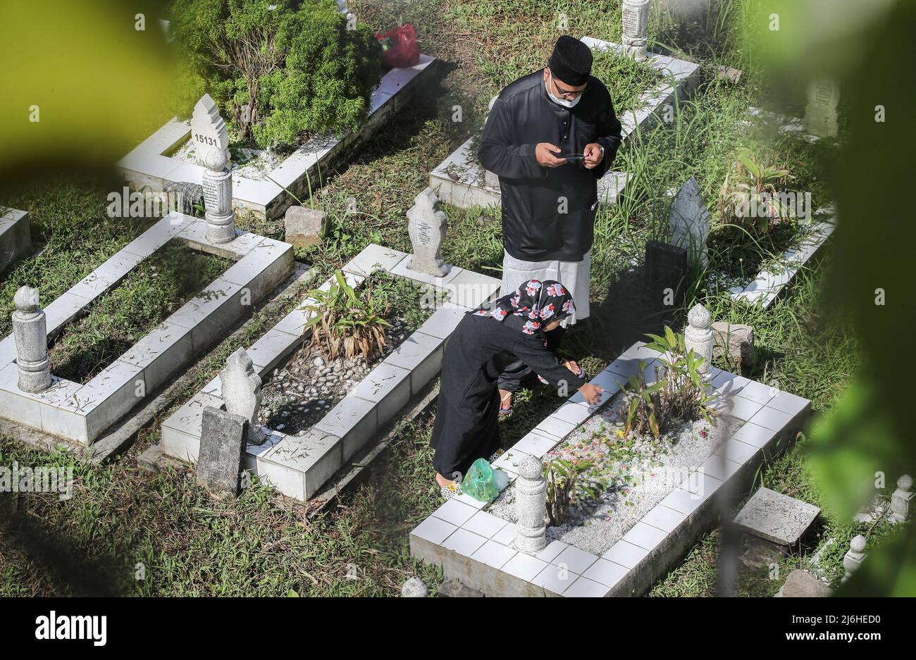 Muslims visit the graves of their loved ones at a cemetery on the first ...