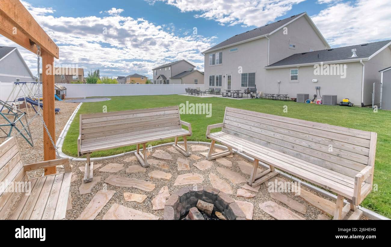 Panorama White puffy clouds Fenced backyard of a house with outdoor ...
