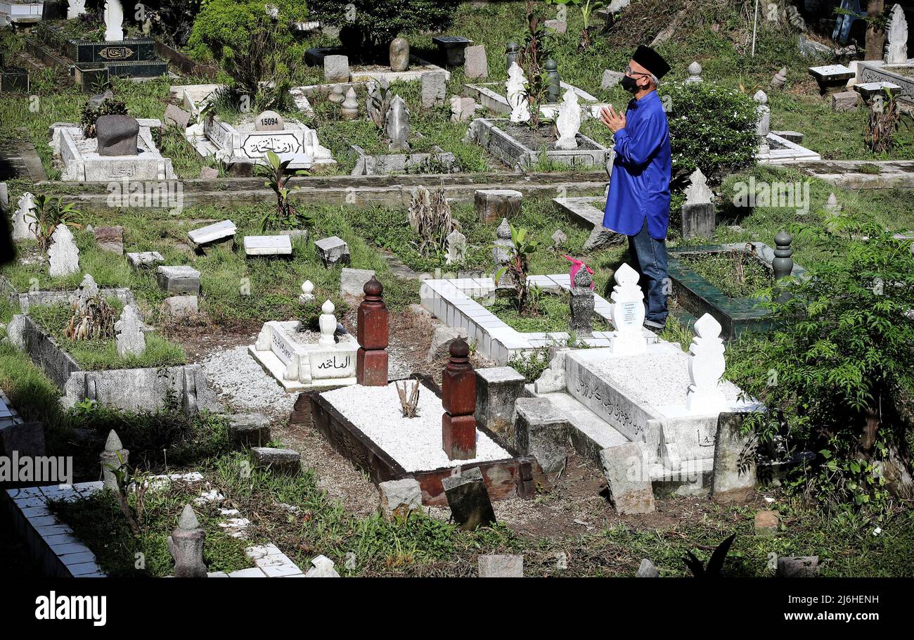 Muslim visits the graves of their loved ones at a cemetery on the first ...